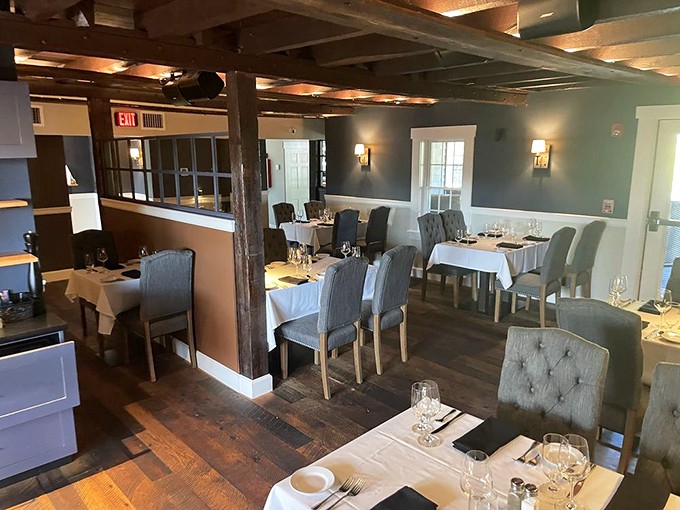 Exposed beams meet modern elegance in this dining room where every table feels like the best seat in the house.