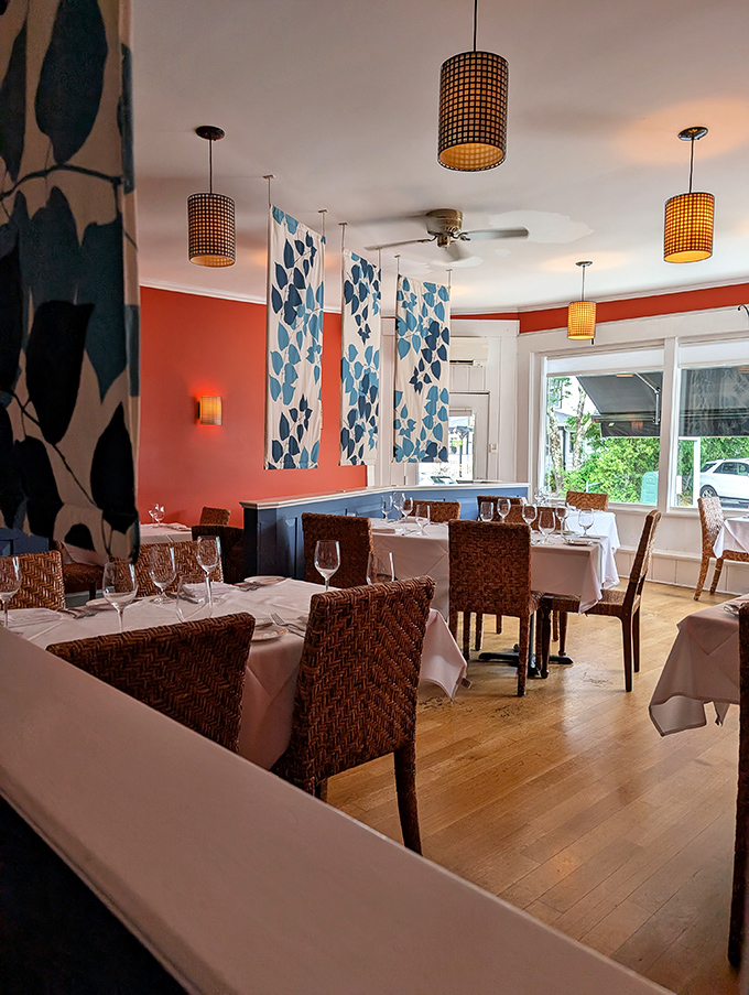 Coral walls and blue leaf tapestries create a dining room that feels both sophisticated and welcoming&mdash;Maine meets the Caribbean.
