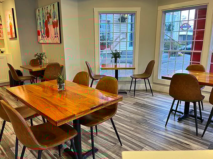 Warm wooden tables bathed in natural light create the perfect canvas for morning masterpieces. Art on the walls, art on your plate.