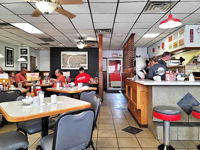 Inside Ray's, the counter seating offers front-row views to short-order magic while ceiling fans lazily spin overhead.