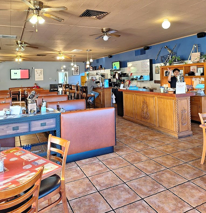 Interior: Cozy booths and wooden accents create the perfect backdrop for morning conversations, while ceiling fans keep the rhythm overhead.