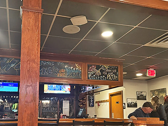 Warm wood paneling and twinkling lights create that rare atmosphere where strangers become friends and regulars feel like family.