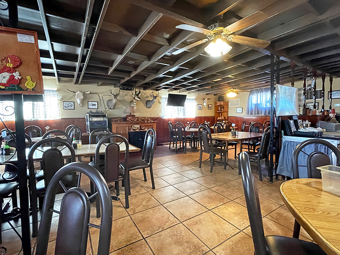 Step inside to a dining room where mounted deer heads and wooden beams create the perfect backdrop for burger bliss.