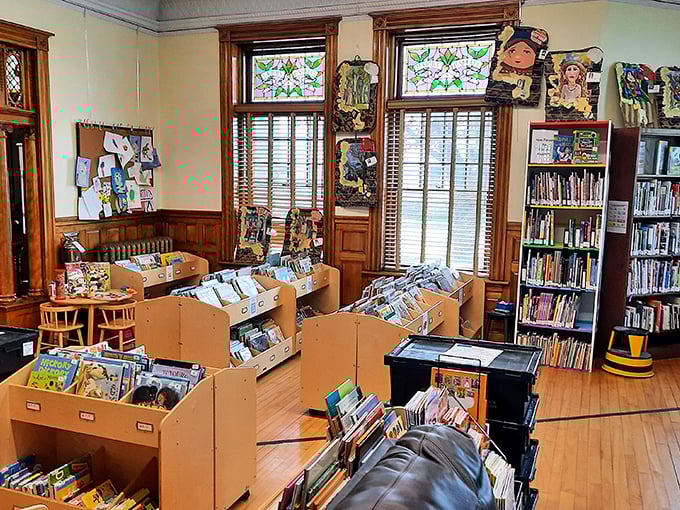 Interior: Warm wooden shelves cradle literary treasures while sunlight streams through stained glass, creating a bibliophile's sanctuary that spans international boundaries.