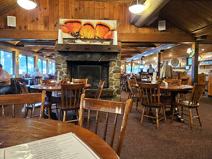 That stone fireplace isn't just for show &ndash; it's the heart of this wood-paneled dining room where comfort meets coastal charm.