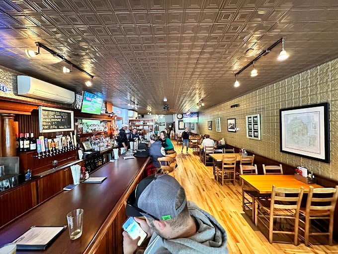 Step inside and you're greeted by a scene that's part 'Cheers', part maritime museum. The warm wood and nautical decor make you feel instantly at home.