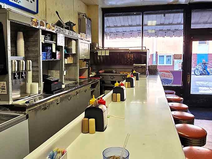 Classic diner counter seating puts you front and center for the griddle show, where burger magic happens daily.