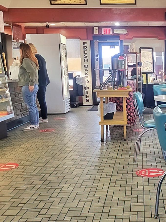 Interior charm that whispers "stay awhile": Vintage tile floors and retro seating create the perfect backdrop for conversations that flow as easily as the coffee.