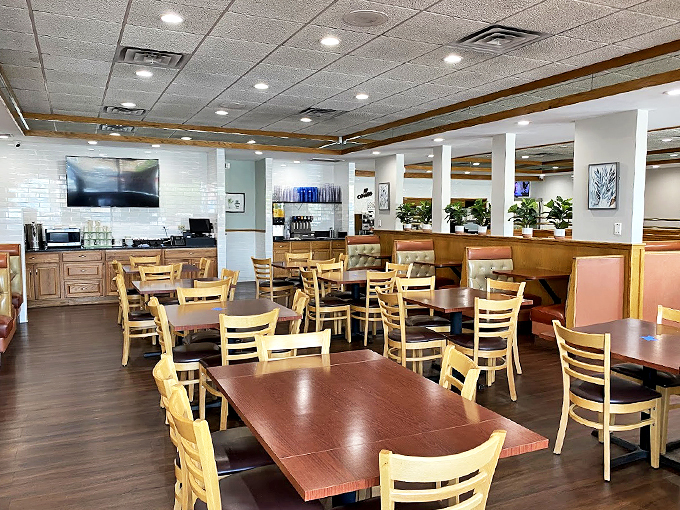Clean lines, warm woods, and cozy booths create a modern diner atmosphere that feels like a breakfast hug.