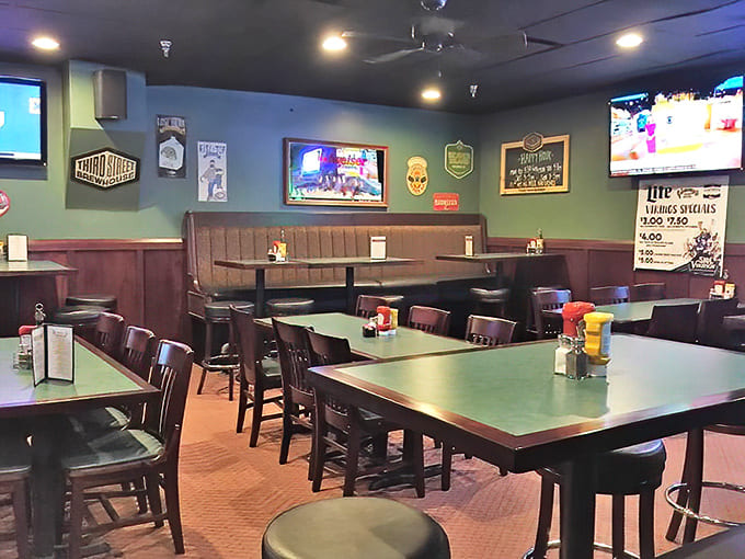 Inside, the green walls and dark wood create the kind of cozy pub atmosphere where strangers become friends over shared baskets of fries.
