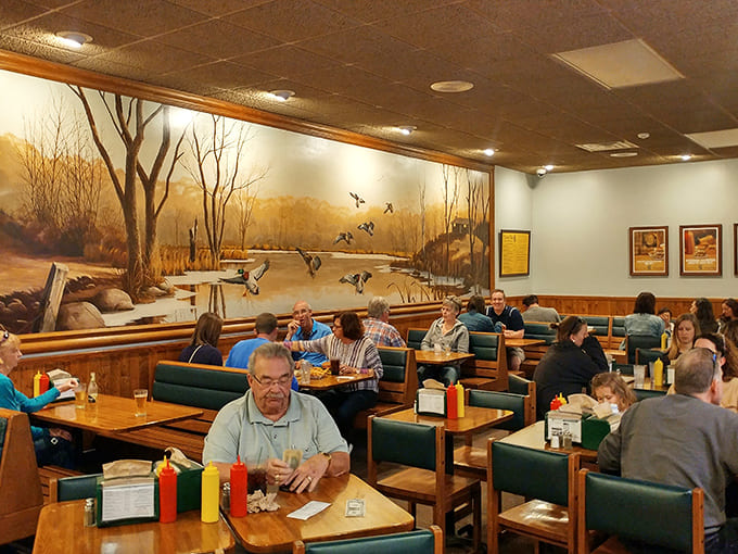Wood paneling, green booths, and scenic murals create the perfect backdrop for serious burger consumption and even more serious conversation.