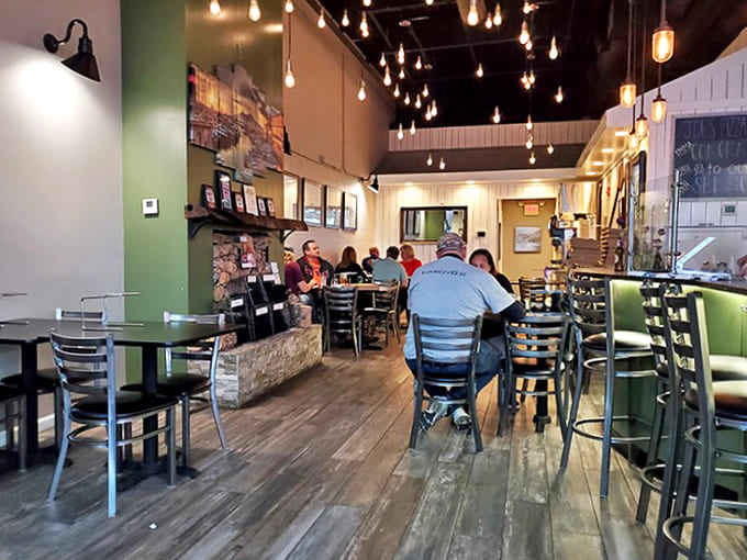 Interior: Warm wooden floors, twinkling string lights, and cozy seating create the perfect backdrop for pizza magic to unfold.