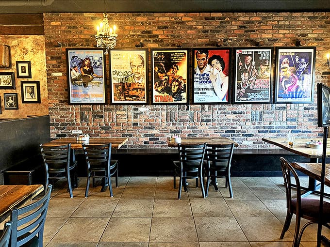 Interior: Exposed brick walls adorned with vintage Italian movie posters create an atmosphere that's both nostalgic and inviting. Cinema meets cuisine in this cozy space.