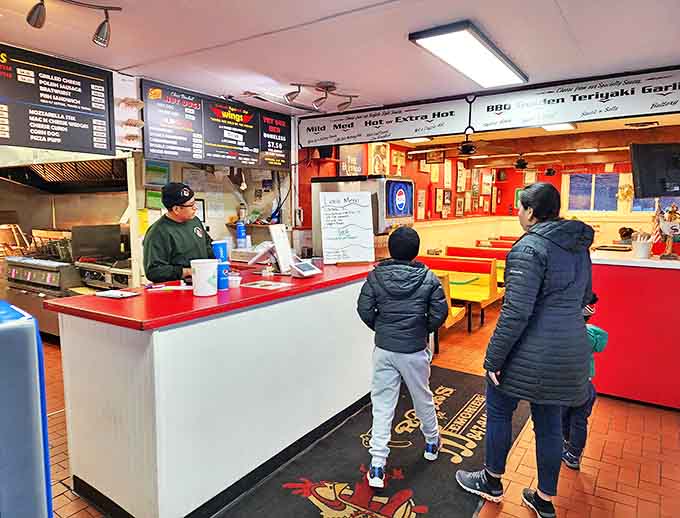 Where wing magic happens! The no-frills counter service setup focuses on what matters most – getting those perfect wings into hungry hands fast.