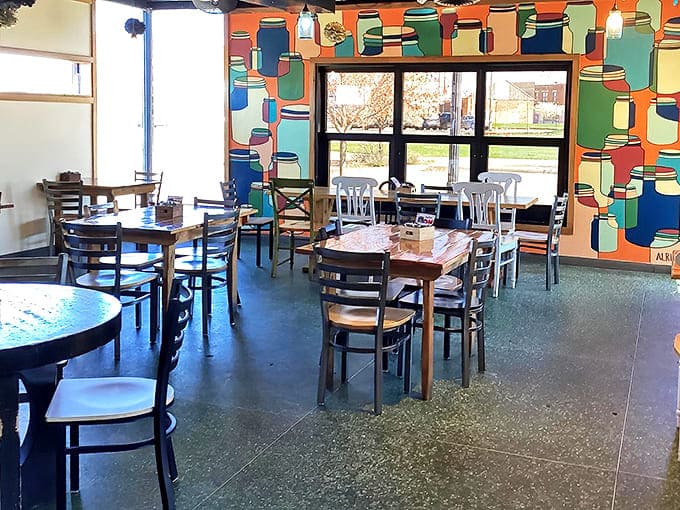 Inside, colorful mason jar artwork transforms ordinary walls into a whimsical dining gallery where comfort meets creativity.