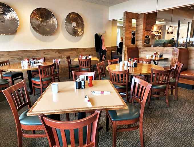 Interior: Warm wood accents and comfortable seating create the perfect backdrop for morning conversations and coffee refills that appear like magic.