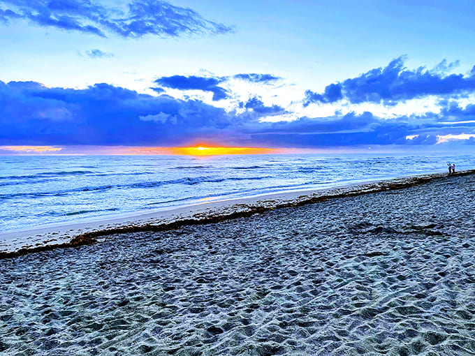 Sunset paints the sky in impossible colors as day bids farewell at Jensen Beach &ndash; nature's own light show without the admission price.