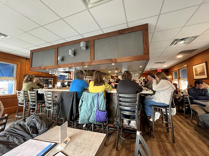 Wood paneling and string lights create the cozy vibe where locals and tourists become temporary best friends.