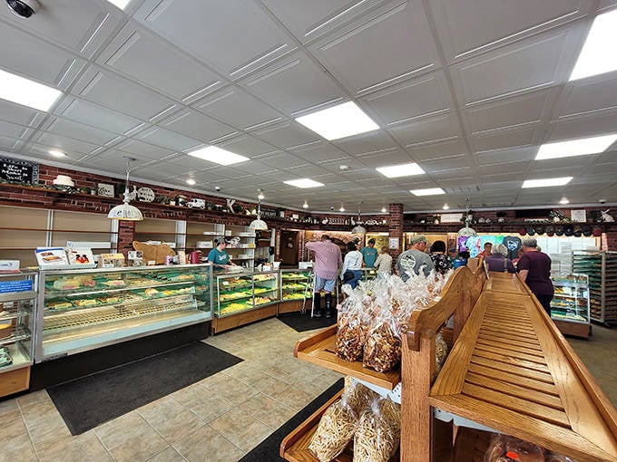 Inside Kennedy's, the bustling bakery floor reveals a choreographed dance of customers selecting their treats while staff keep display cases stocked with fresh-baked wonders.