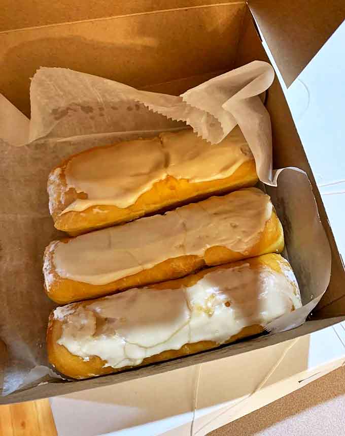 Eclairs: These aren't just eclairs &ndash; they're time machines disguised as pastry. Perfectly glazed chocolate tops hiding custard that would make French chefs nod in approval.