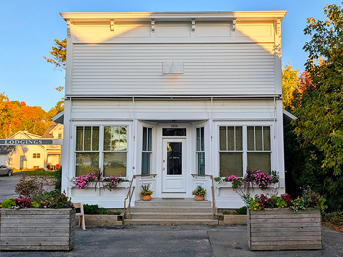 This charming white storefront whispers tales of simpler times, when shopping was personal and flower boxes were mandatory.
