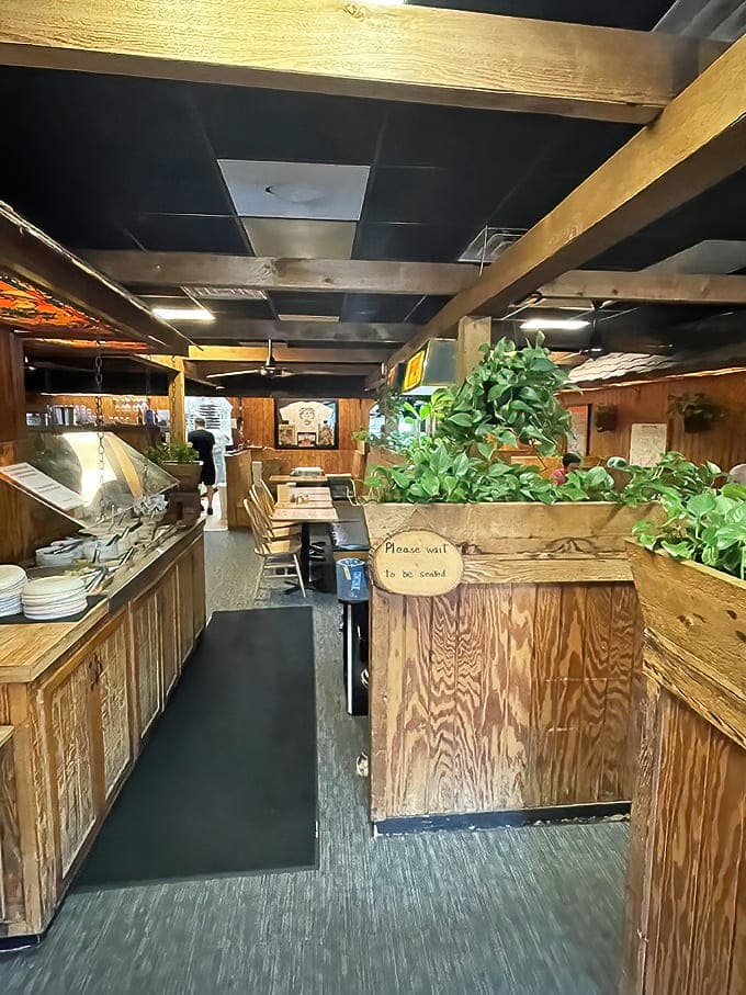 Wooden booths and rustic charm create that "been here forever" vibe where conversations flow as freely as the garlic butter.