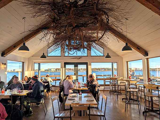 Floor-to-ceiling harbor views and rustic chandeliers create the perfect backdrop for your seafood feast, no Instagram filter needed here.