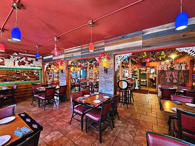 Step inside to discover a vibrant dining room where warm red tones and eclectic decor create an atmosphere that's pure joy.