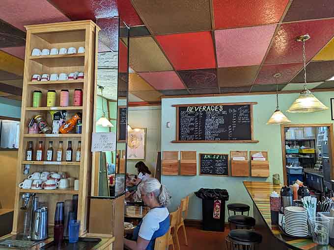 Step inside and the color party continues with a ceiling that looks like a rainbow exploded in the best possible way.