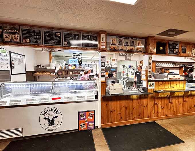 Behind the counter, Moomers' warm wooden interior creates a cozy farm atmosphere where ice cream dreams come true.