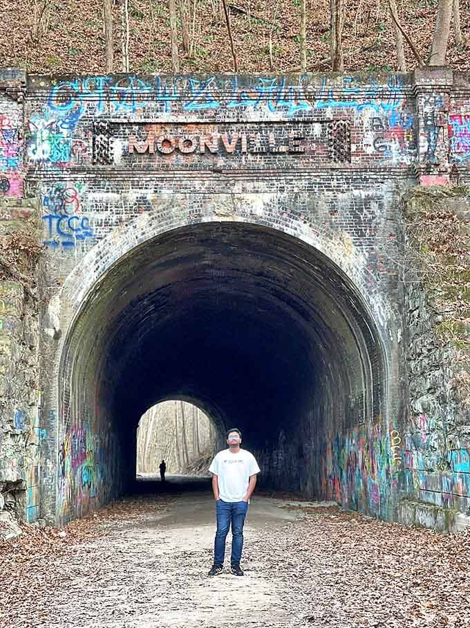 Brave souls stand at the threshold of history, where daylight barely penetrates the tunnel's mysterious depths.