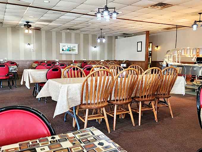 Simple elegance defines the dining room, where wooden chairs and clean tablecloths create an atmosphere of unpretentious comfort.
