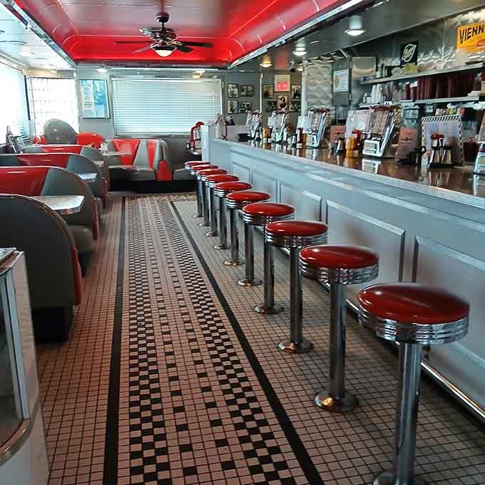 Step inside and the retro magic continues with red ceiling, chrome counter, and stools that have seen countless milkshake moments.