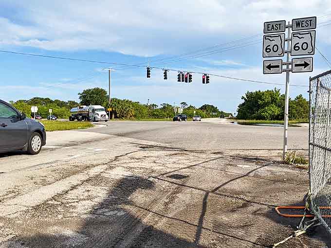 Highway 60 stretches toward the horizon at Yeehaw Junction, where road signs point east and west, guiding travelers through this historic Florida crossroads.