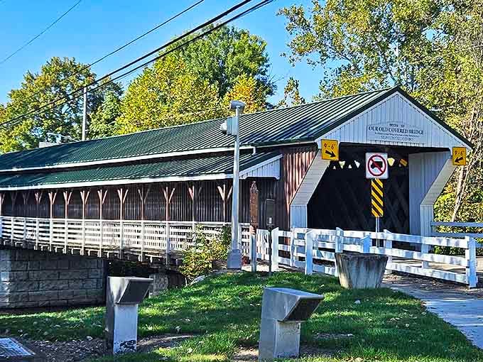 The historic covered bridge stands as a wooden sentinel over the Mahoning River, connecting past and present with every crossing.