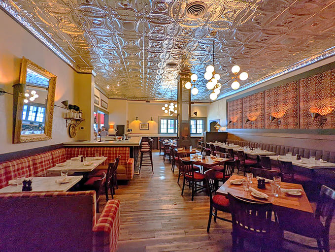 That tin ceiling alone has witnessed more dinner conversations than a therapist, gleaming above diners since the Greatest Generation was young.