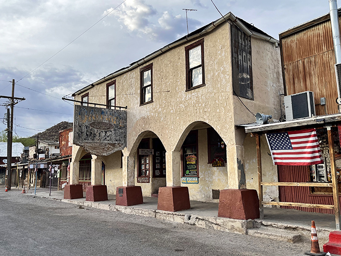 History stands tall in this weathered building, its arched walkway offering shade from the desert sun and glimpses into Arizona's gold rush past.