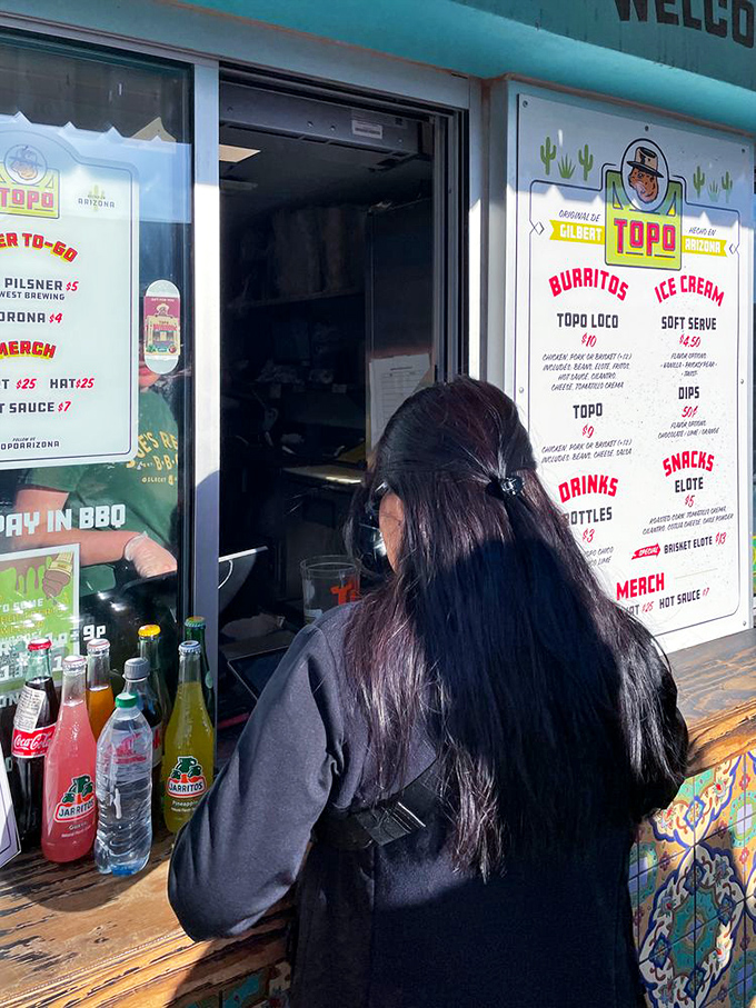 The menu board tempts with simple pleasures - burritos, ice cream, and elote that'll make your taste buds dance.