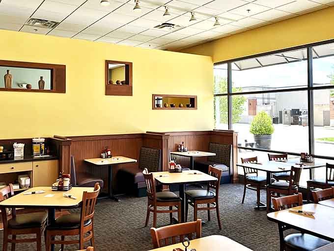 Warm yellow walls and wooden accents create a cozy atmosphere where breakfast dreams come true and diet plans go to die.