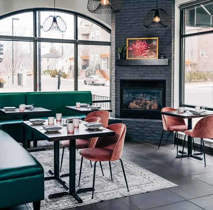 Emerald banquettes meet dusty rose chairs in a space that's Instagram-ready without trying too hard to be.