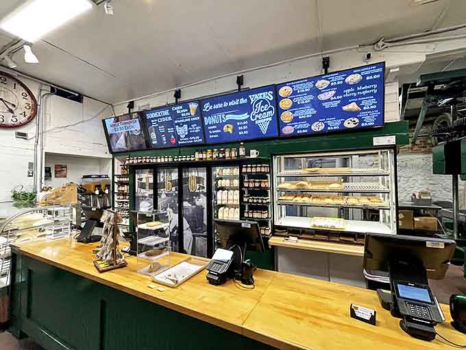 Interior: Inside the mill, history meets hunger as customers line up for that perfect combination of fresh cider and warm donuts.