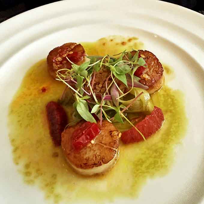 Scallops that would make Neptune himself jealous, perfectly seared and swimming in a buttery sauce that demands bread for sopping.