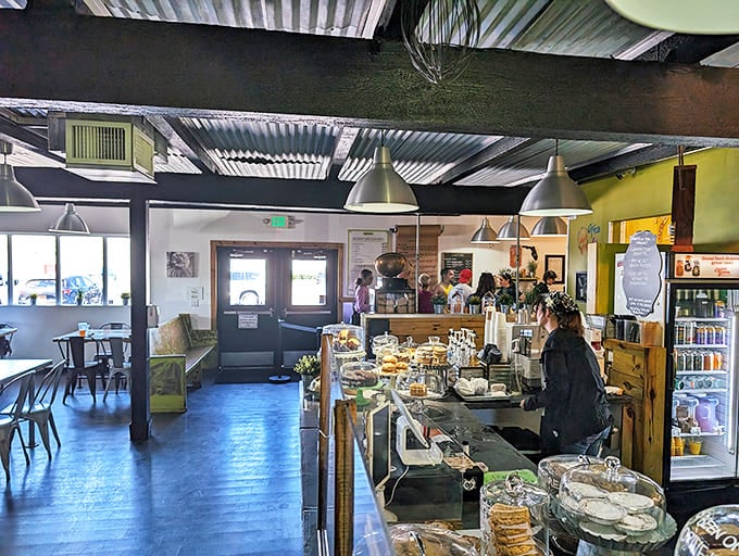 Industrial meets homey in this bright space where exposed beams and metal fixtures play against warm yellow walls and communal tables.