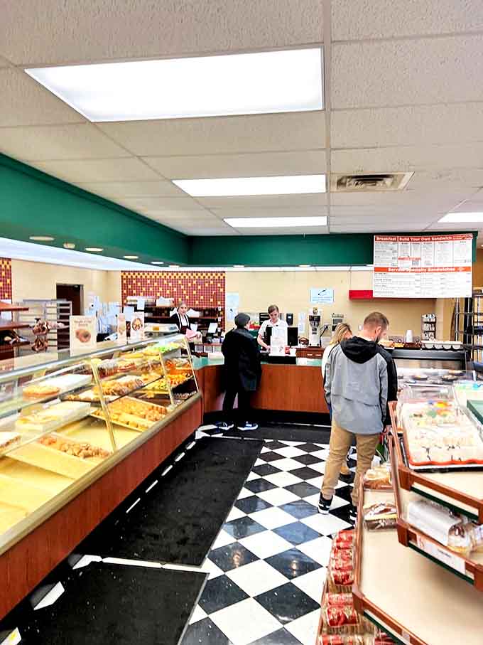 Inside, the classic black and white checkered floor leads hungry visitors to display cases brimming with freshly baked treasures.