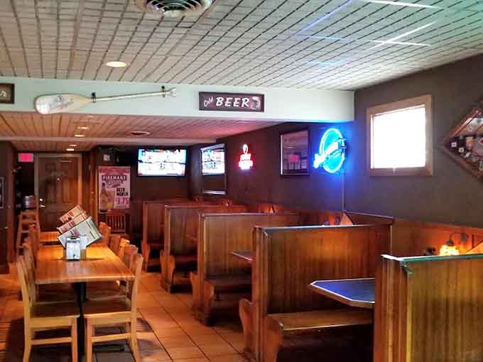 Wooden tables and warm lighting create the perfect neighborhood grill atmosphere where comfort food dreams come true every single day.