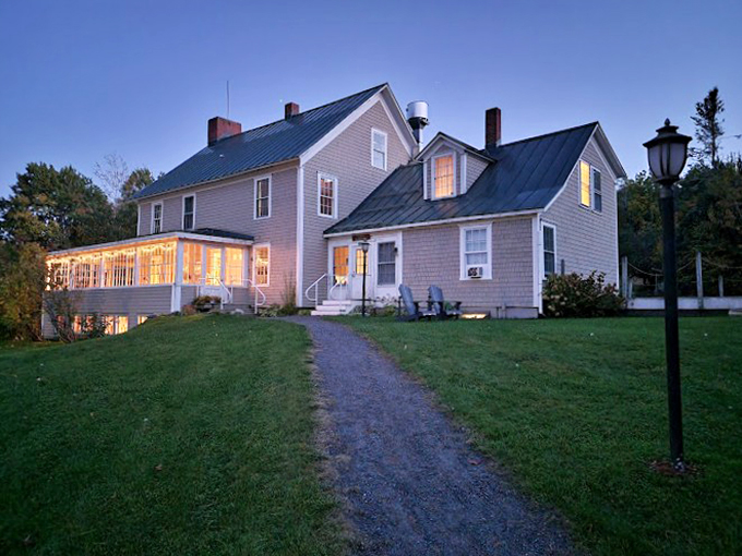 As twilight descends, Seyon Lodge glows like a warm welcome beacon, its wraparound porch inviting weary travelers home.