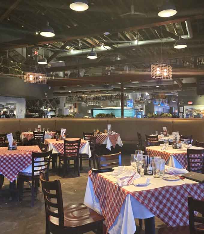 Industrial chic meets coastal comfort in this dining room where exposed pipes and warm lighting create an atmosphere that's both edgy and inviting.