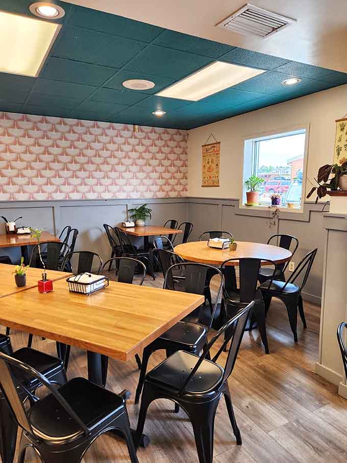 Step inside to find a cheerful space where teal ceilings meet geometric walls, creating the perfect backdrop for ice cream happiness.