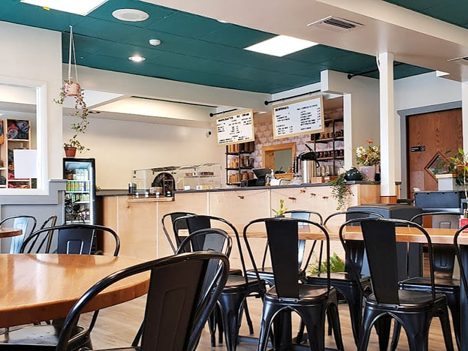 Step inside to discover a space where teal ceilings meet wooden warmth, creating an atmosphere that's equal parts coffee shop chic and North Shore cozy.