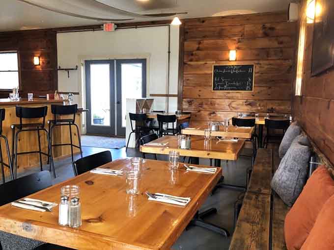 Warm wood tones and casual seating create the perfect atmosphere for serious pizza consumption and casual conversation.